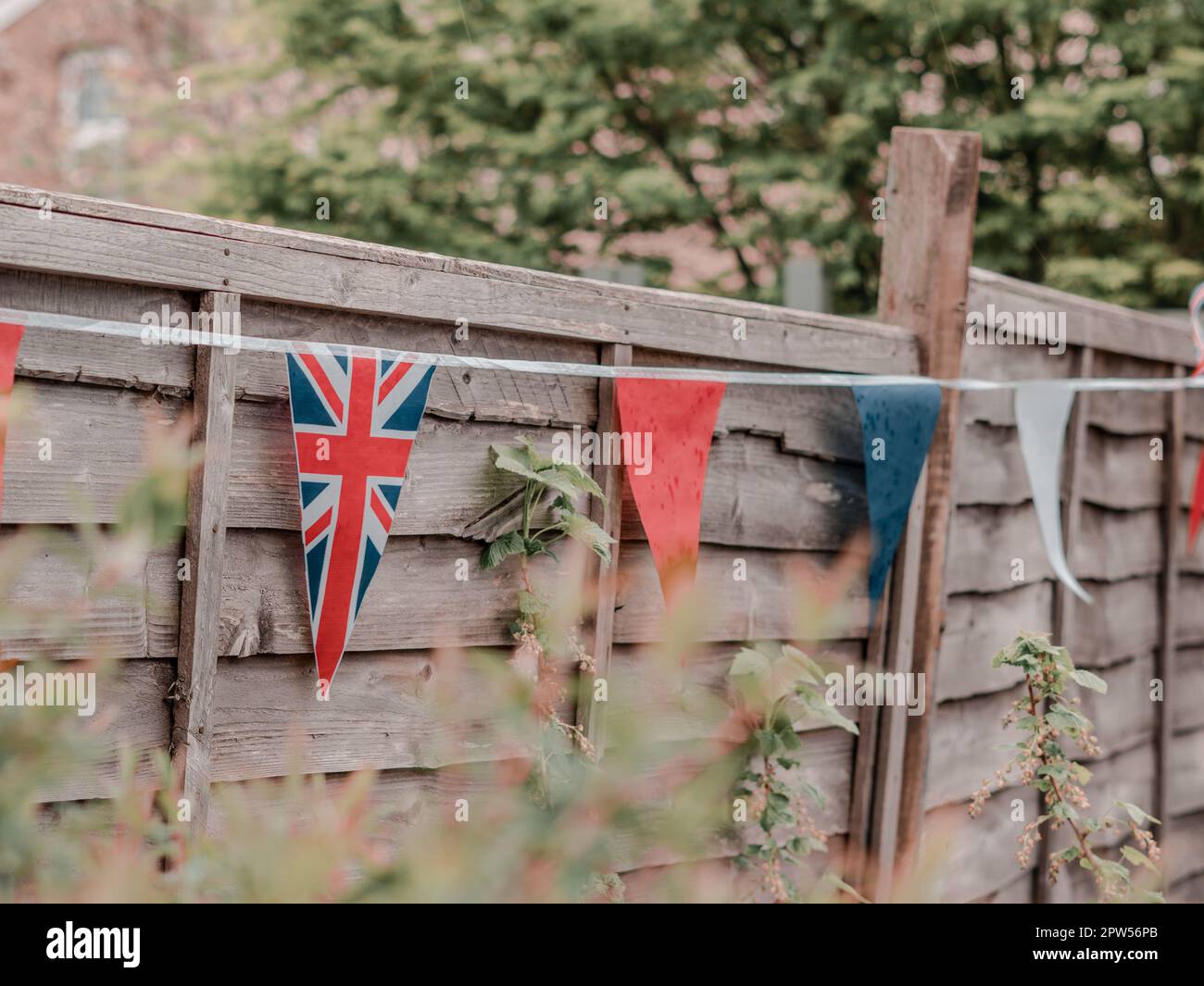 Flags of Great Britain waving on the wind in the garden of English ...