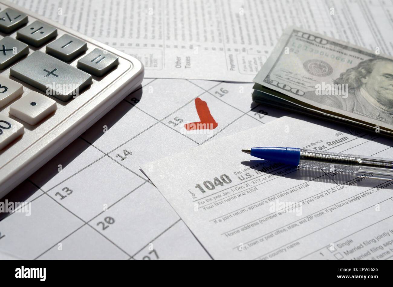 1040 Individual Income Tax Return blank with dollar bills, calculator ...