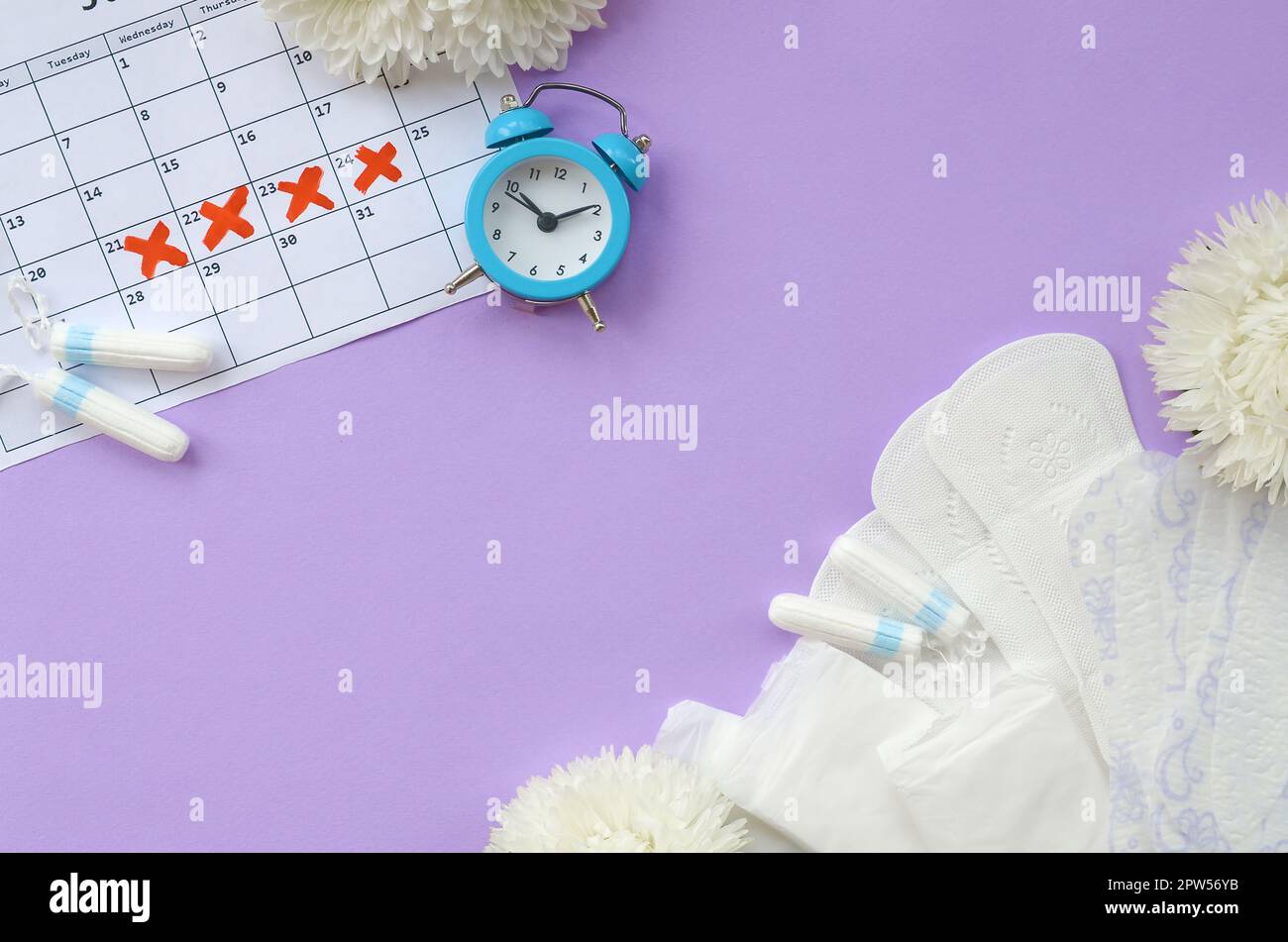 Menstrual pads and tampons on menstruation period calendar with blue ...