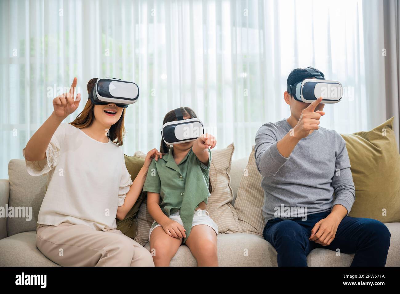 Happy family have mother father and daughter watching movie or playing ...