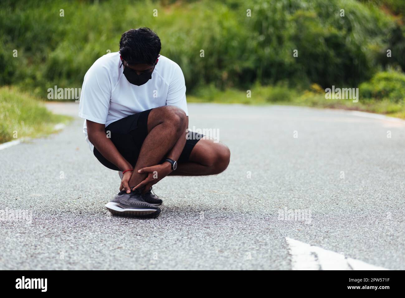 Close up Asian young sport runner black man wear watch hands joint hold ...