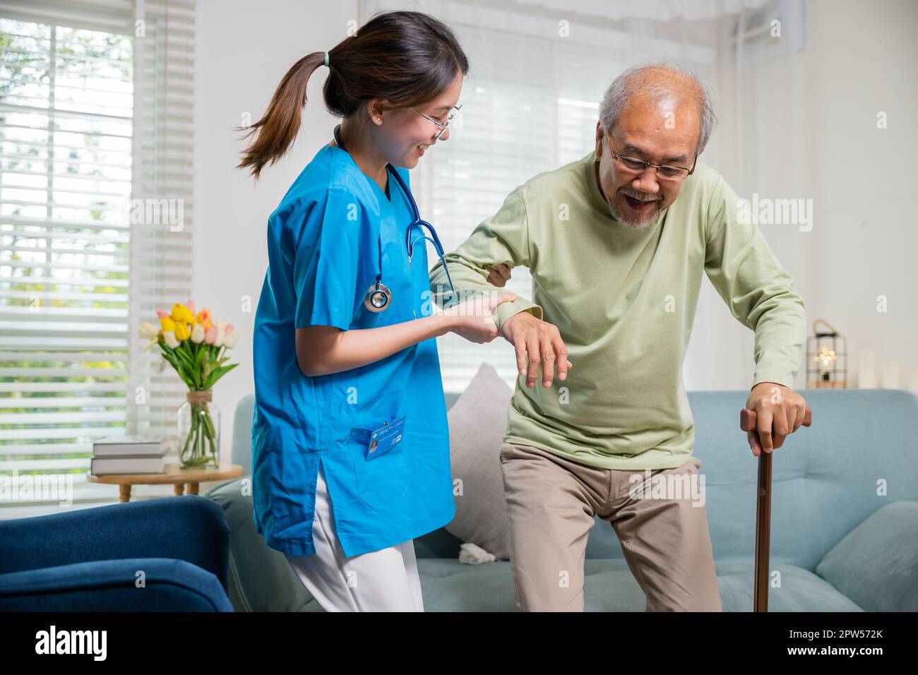 Young woman help support orthopedic patients to get up with walking ...