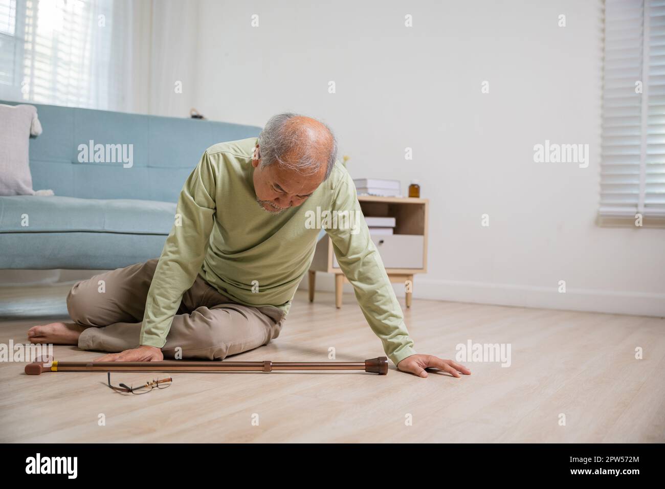 Older senior man headache lying on the floor after falling down he pain ...