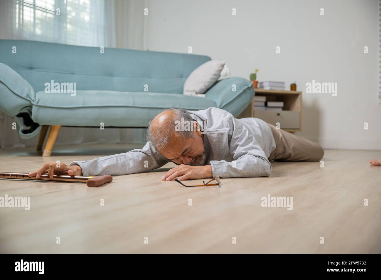 Older senior man headache lying on the floor after falling down he pain ...