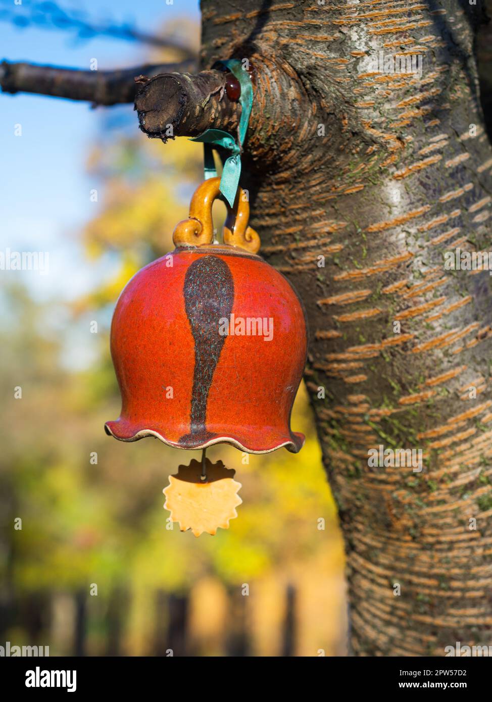 ancient and retro bell hang on a tree Stock Photo - Alamy