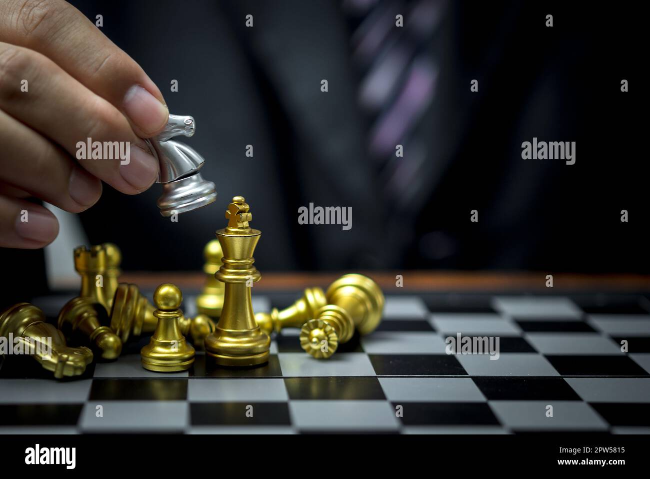 hand of businessman moving chess figure in competition success play ...
