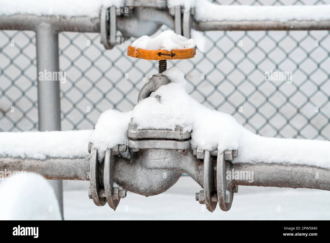 A gas pipe with a valve. Stopcock of the gas pipeline in a snow Stock ...