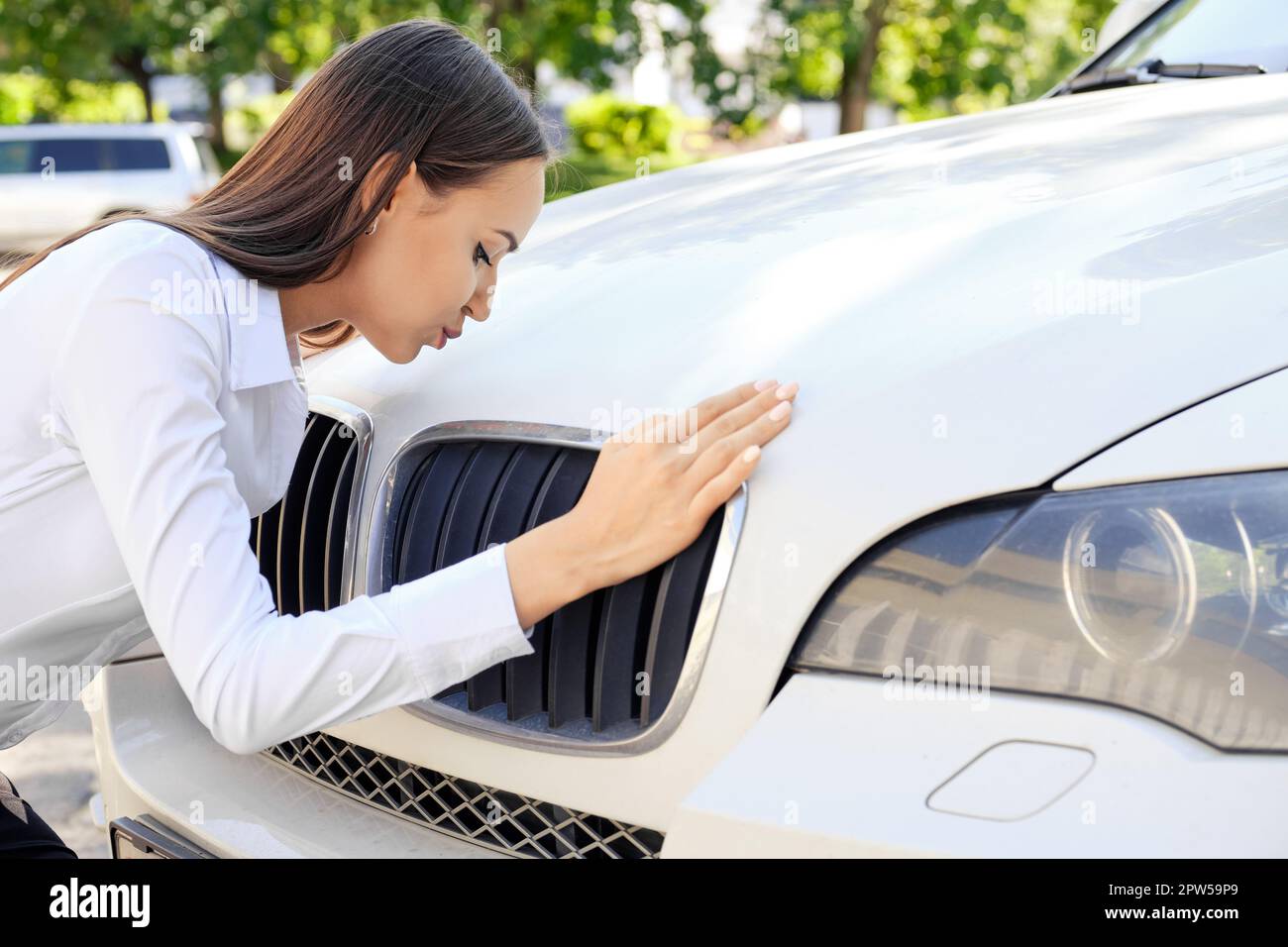 Happy girl kissing her car Stock Photo - Alamy