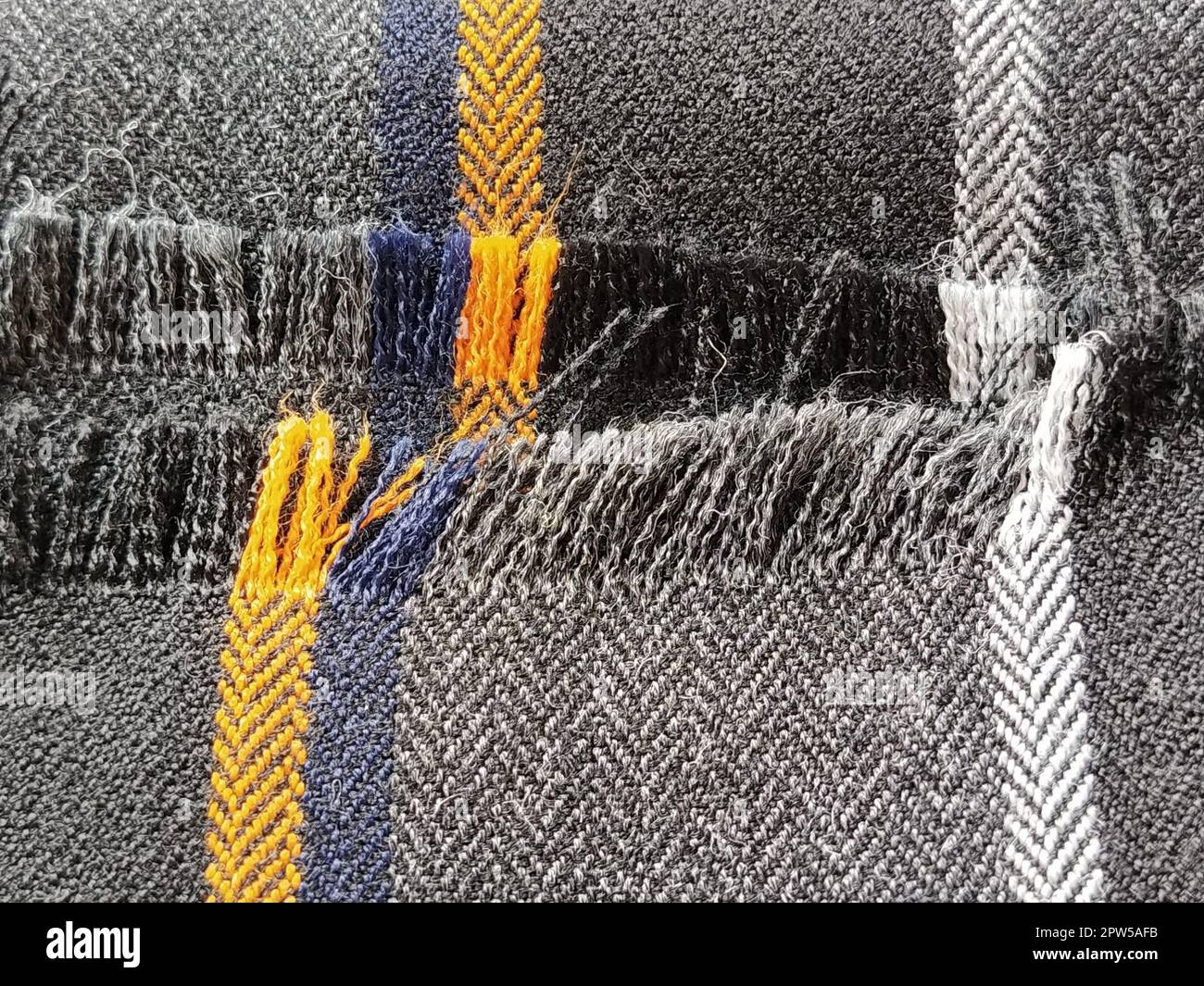 Light black-gray folded fabric with orange and dark blue stripes ...