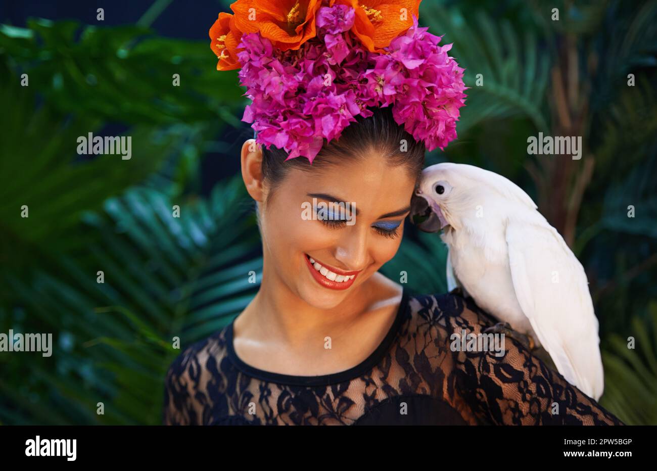 Pretty polly. an exotic looking woman with a parrot perched on her hand ...