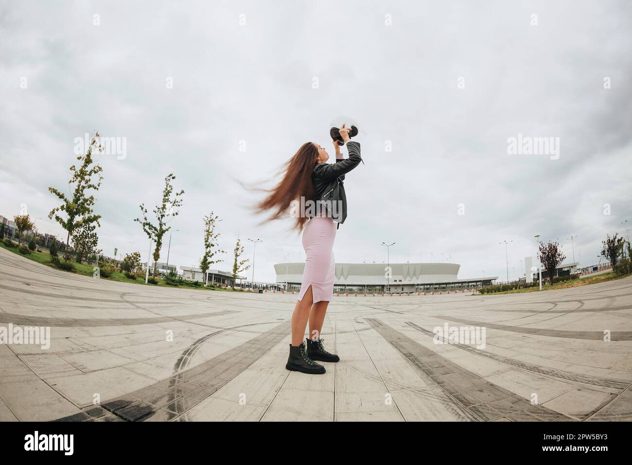 Bottom view of young attractive woman biker wearing bike safety helmet ...