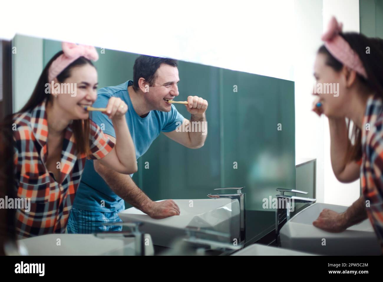 Happy Young brunette Couple Brushing Teeth In Bathroom, Loving Man and ...