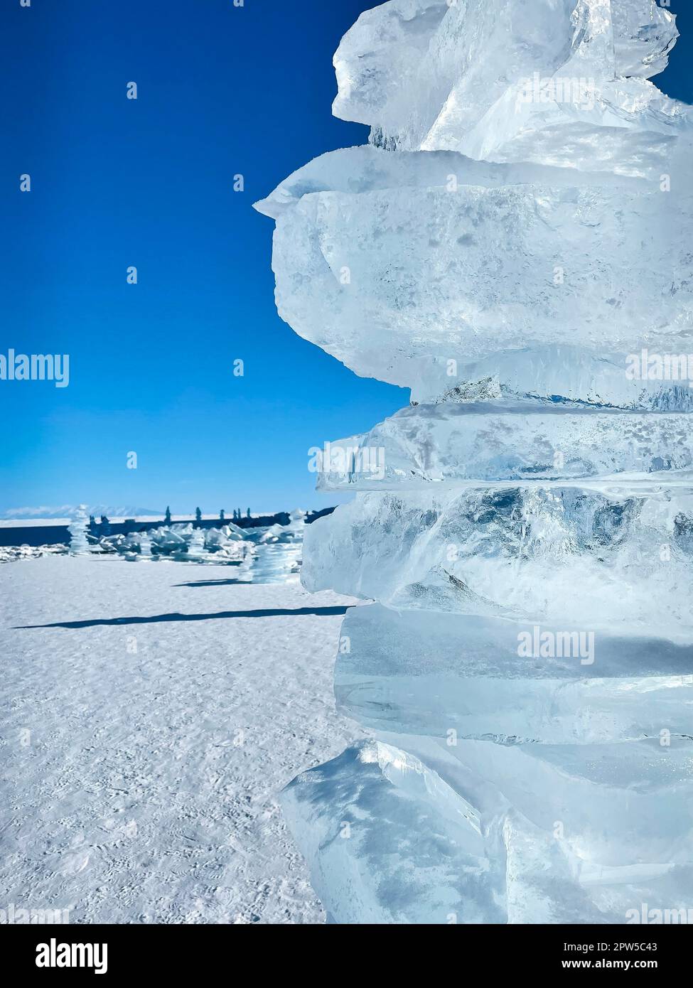 Pieces of ice lying on the ideal smooth ice of baikal with ice hummocks ...