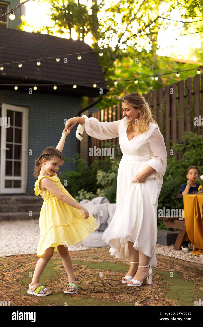 Mother and little daughter having fun outdoors. Wedding, beautiful ...