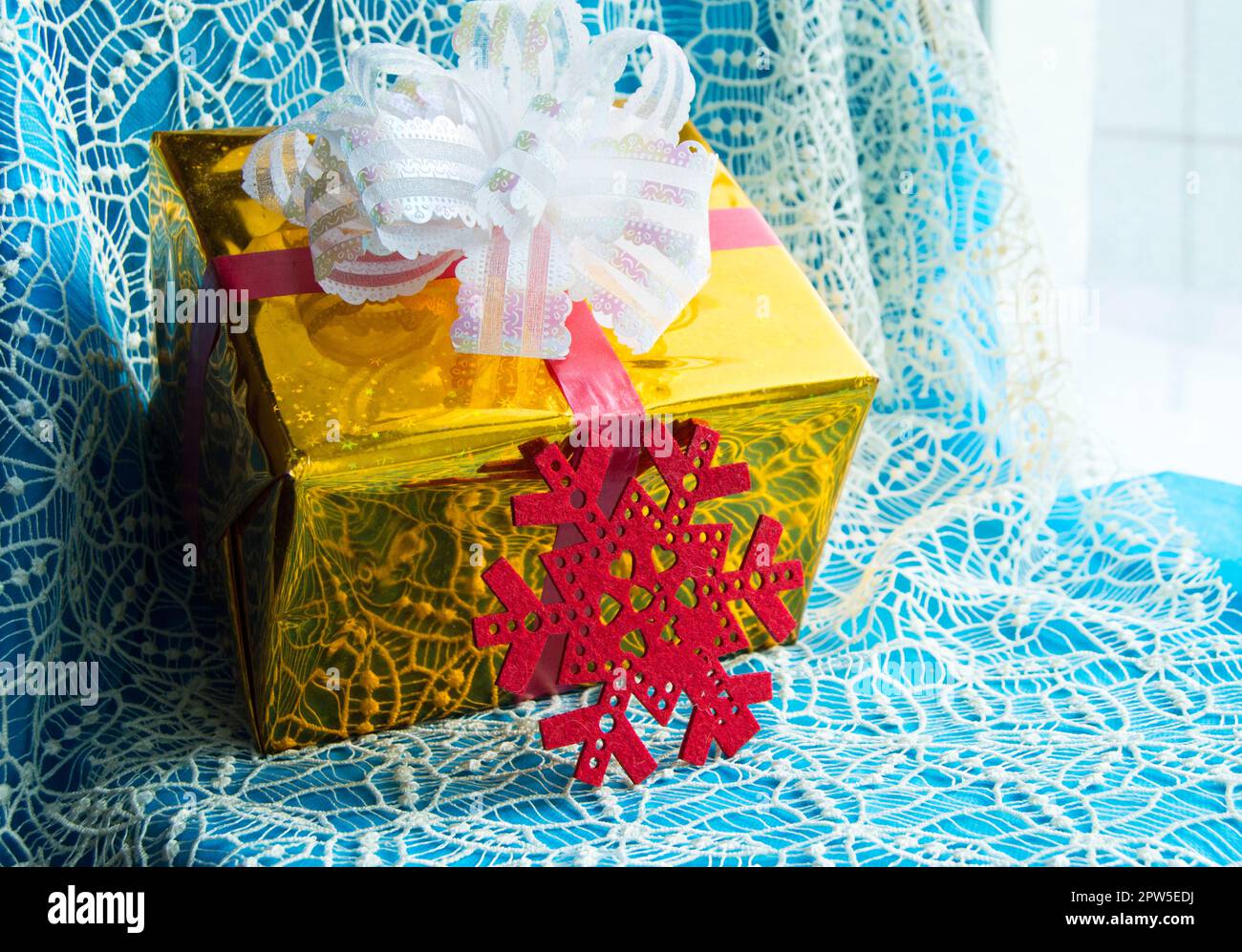 Gift in a Golden package and snowflake beautiful blue background Stock ...