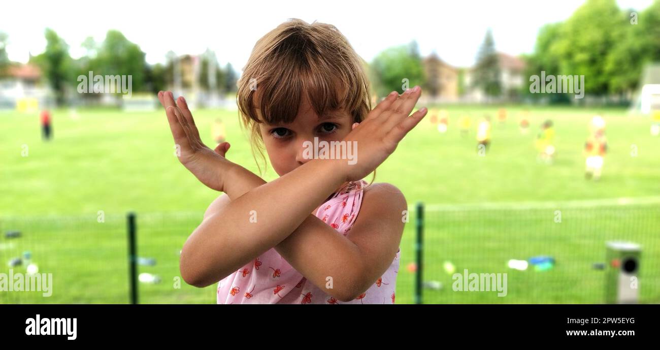 Beautiful girl with brown hair shows hand gestures. Crossing of hands ...