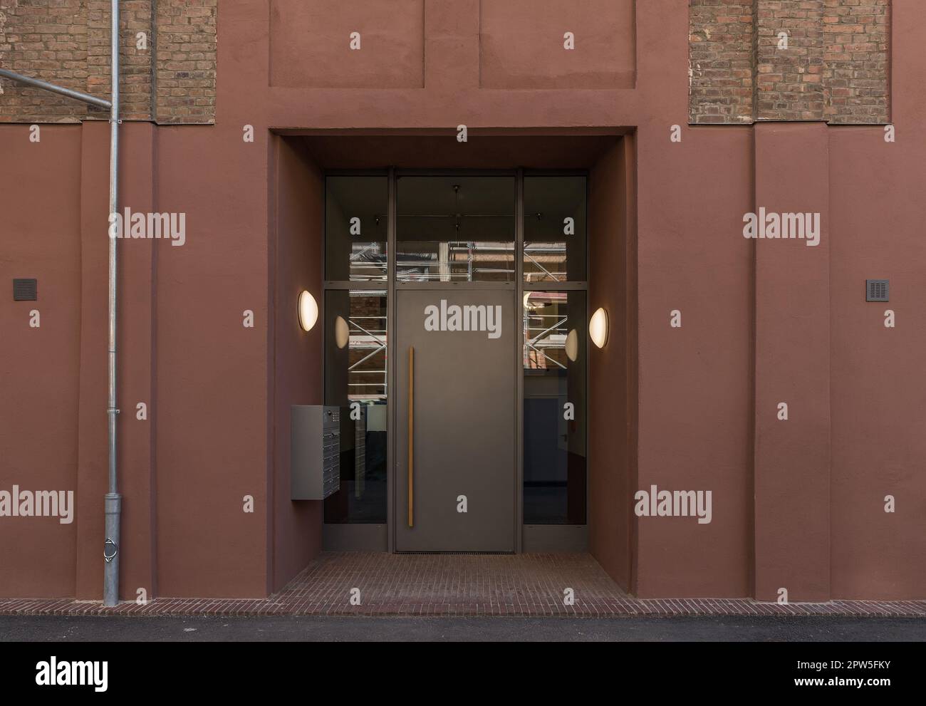 Restored entrance area of an old factory building Stock Photo - Alamy