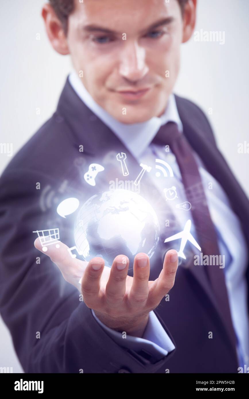 Holding the future in his. A handsome young businessman using ...