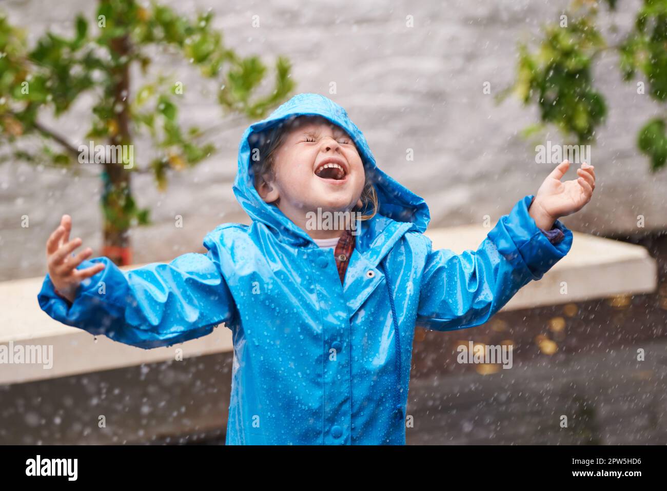 Raindrops and happiness. a young girl enjoying the rain outside Stock ...