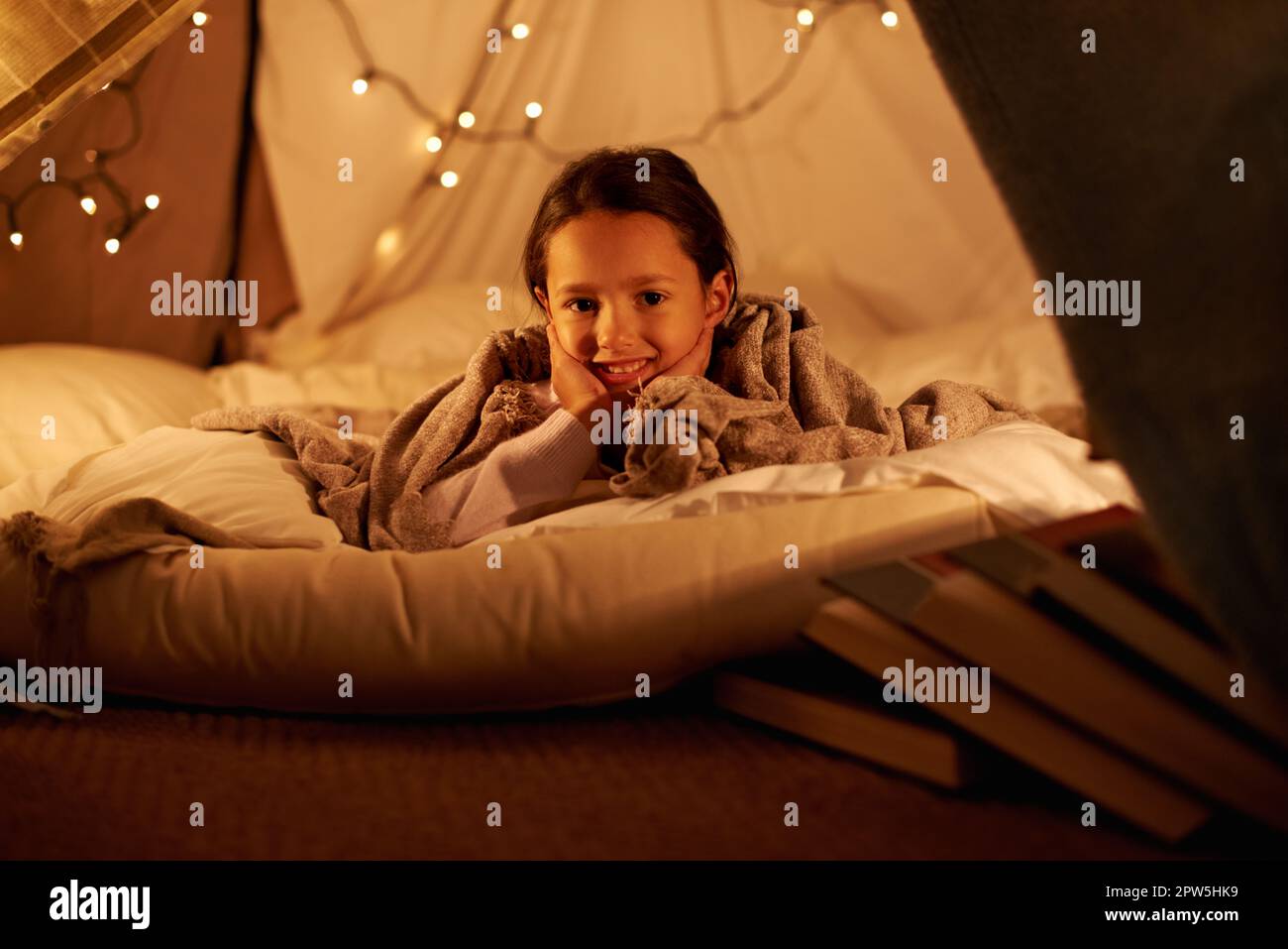 Im having my own sleepover. a happy little girl in a blanket fort Stock ...