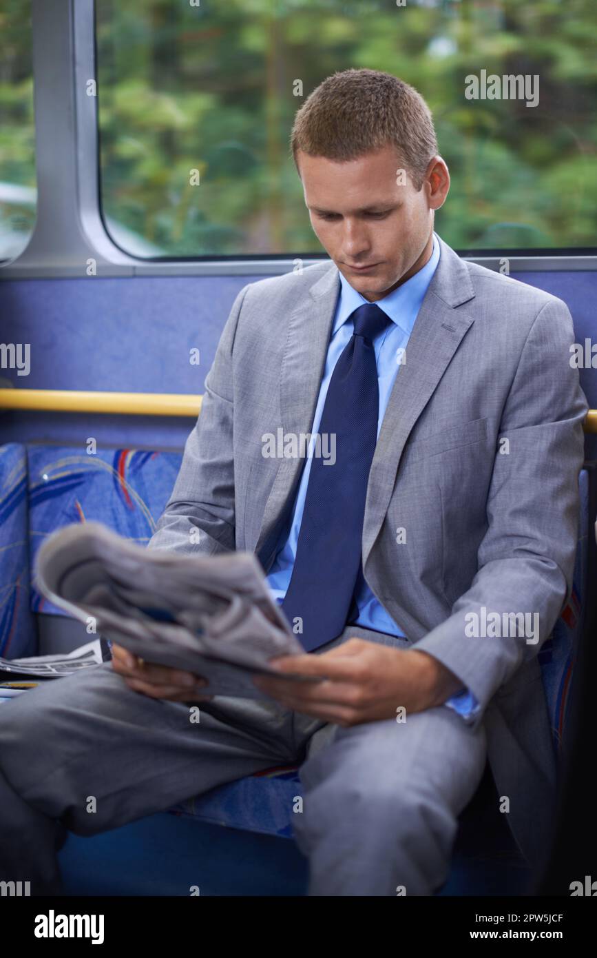Man on bus reading newspaper hi-res stock photography and images - Alamy