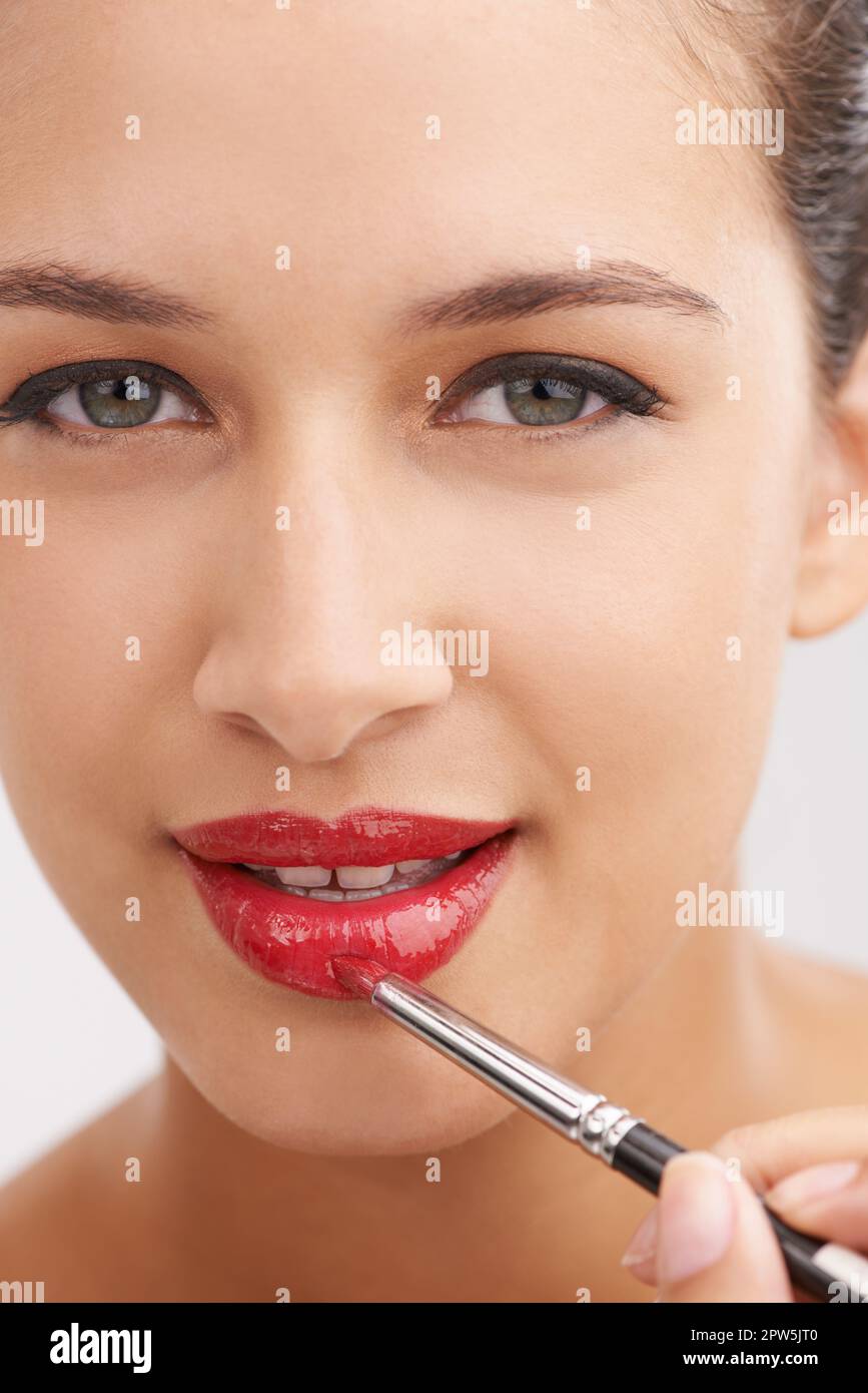 My Favorite Shade Of Red A Beautiful Young Woman Applying Lip Gloss