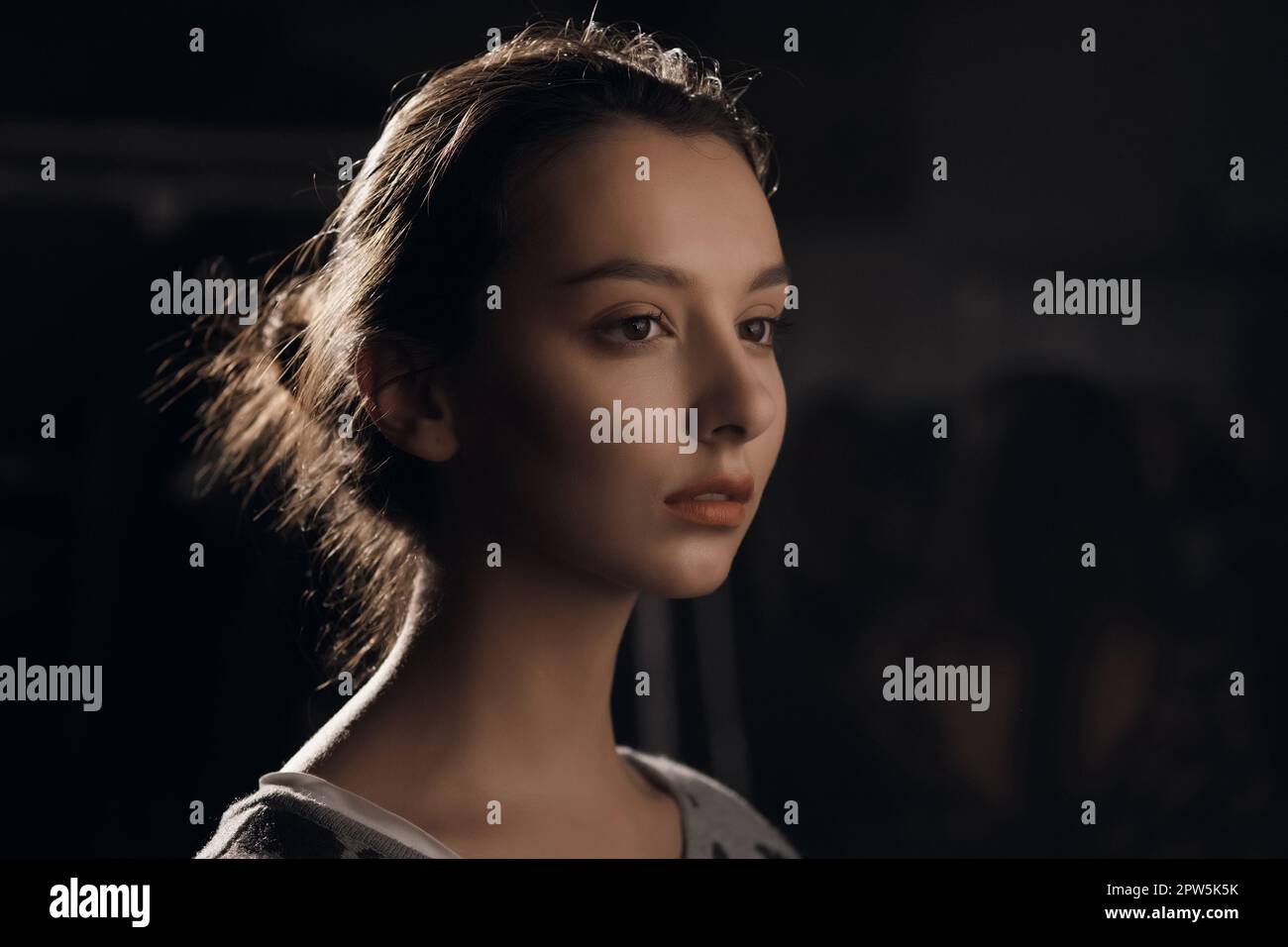 Low key close up photo of calm girl in profile Stock Photo - Alamy