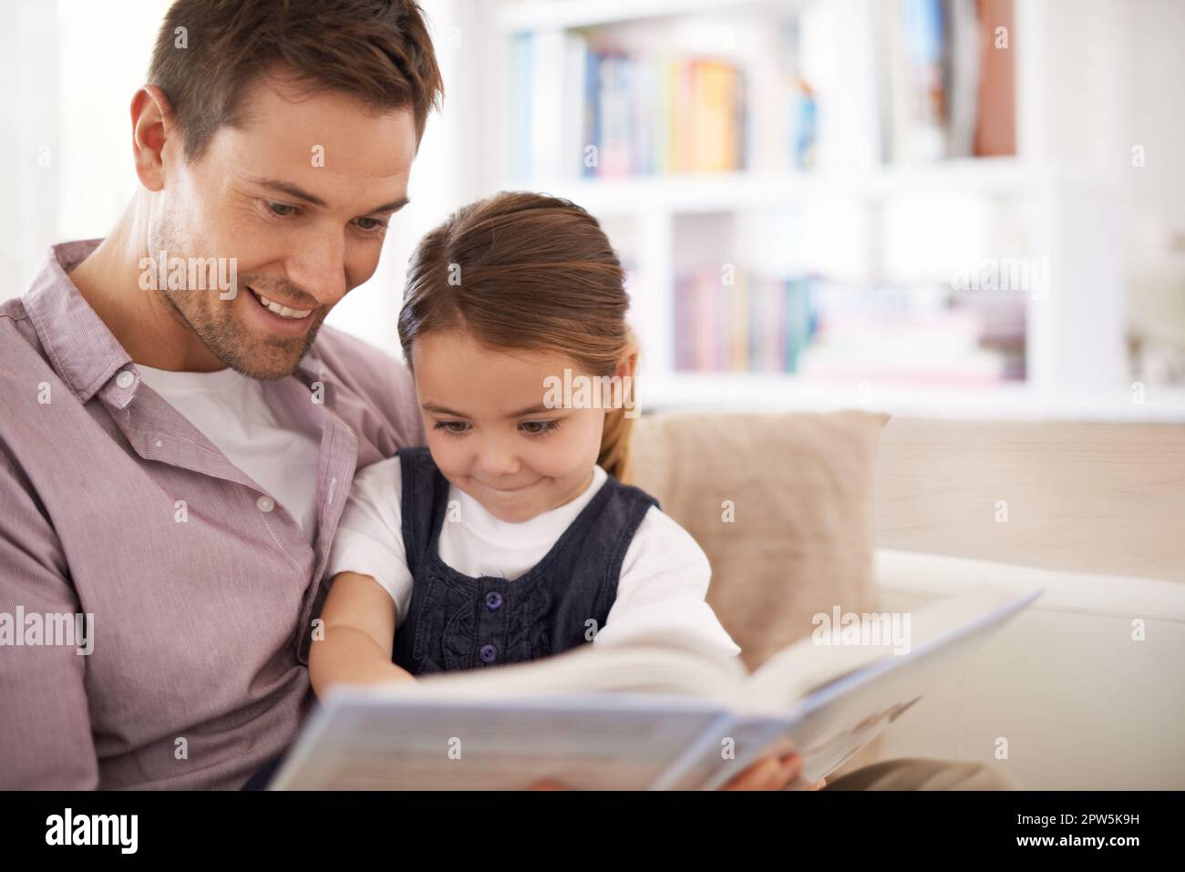 Getting lost in the fairytale. a young father reading a book with his ...