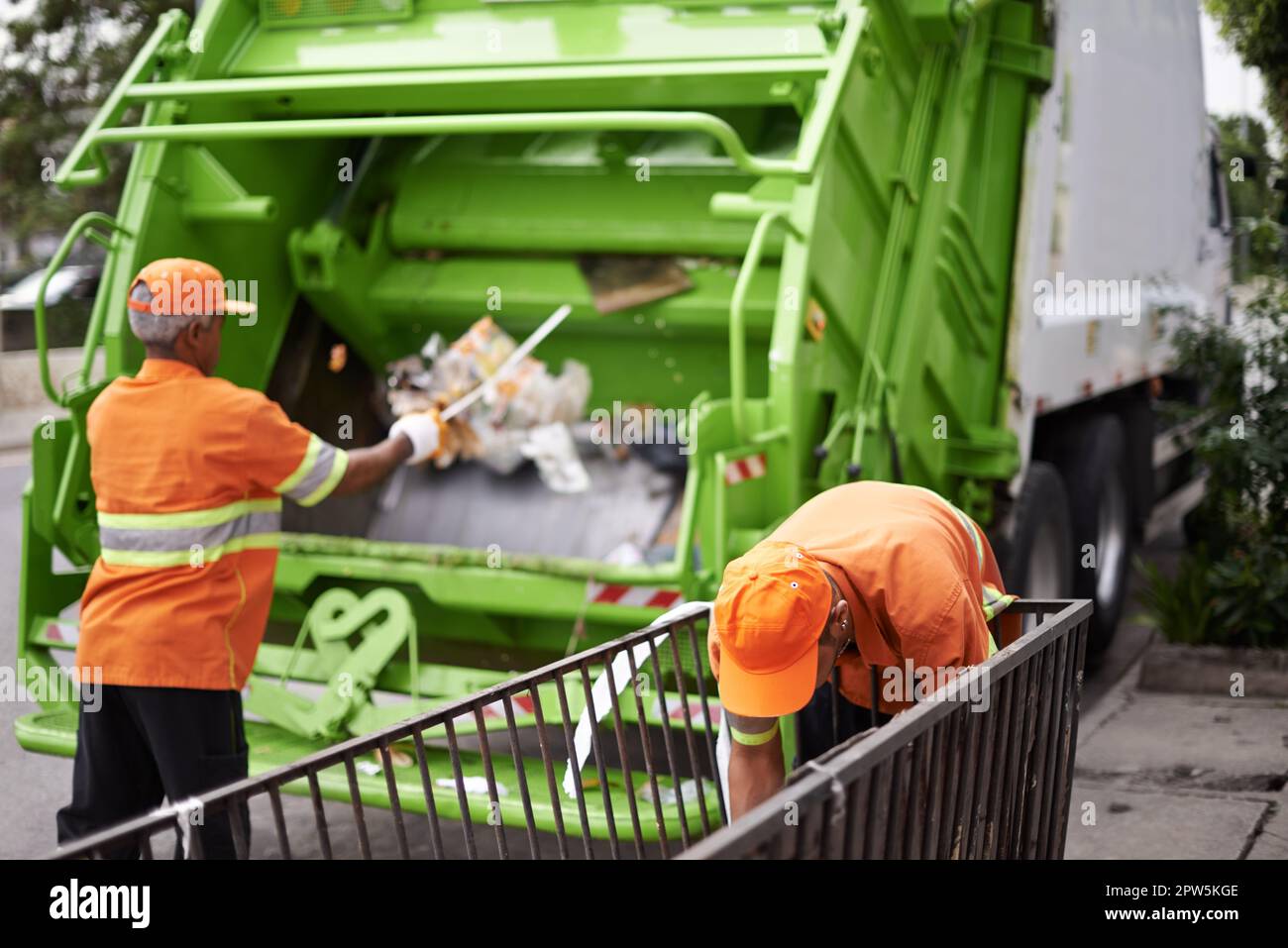 Garbage collection day. a garbage collection team at work Stock Photo ...