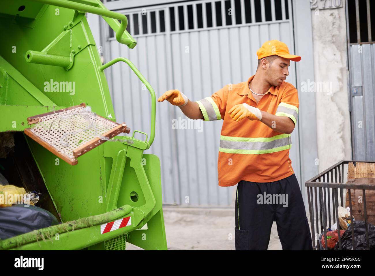 Hes a hard worker. a busy garbage collection worker Stock Photo - Alamy
