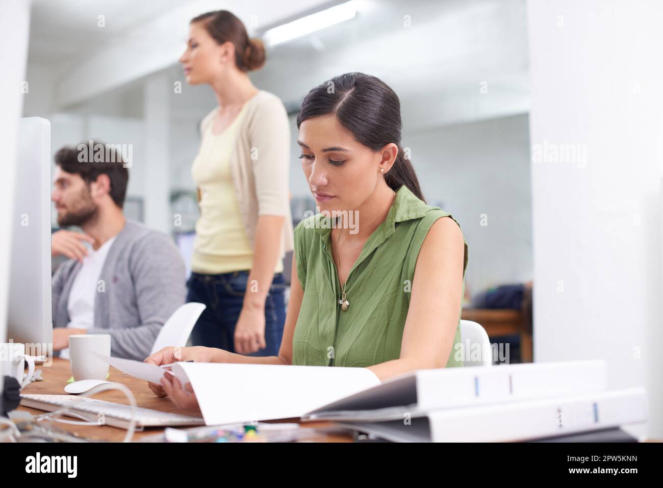 Getting down to business. A young businesswoman working at her desk in ...