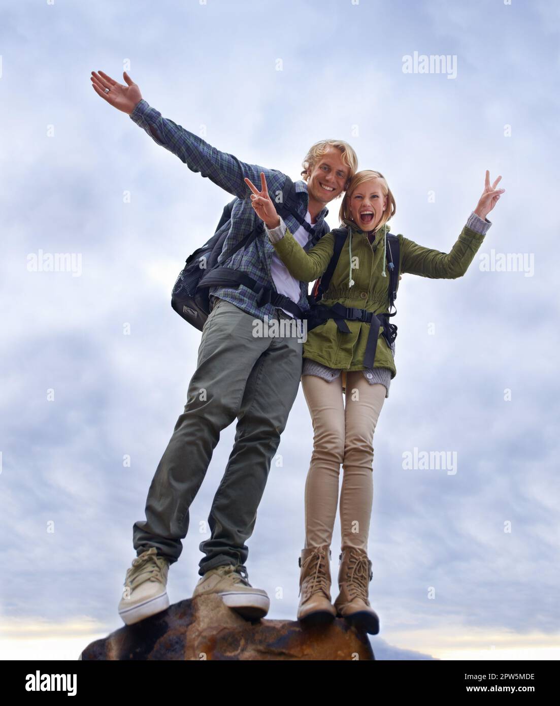 Living on the edge and loving it. Low-angle view of a happy young ...