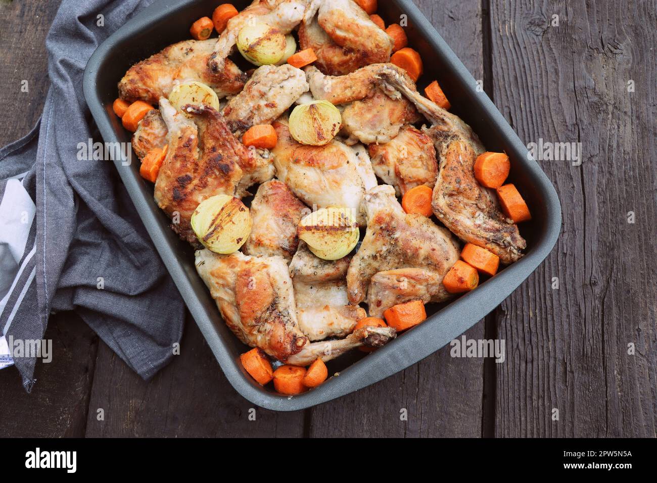 Roasted Rabbit Haunches in Pan with Stewed Vegetables on Rustic Wooden ...