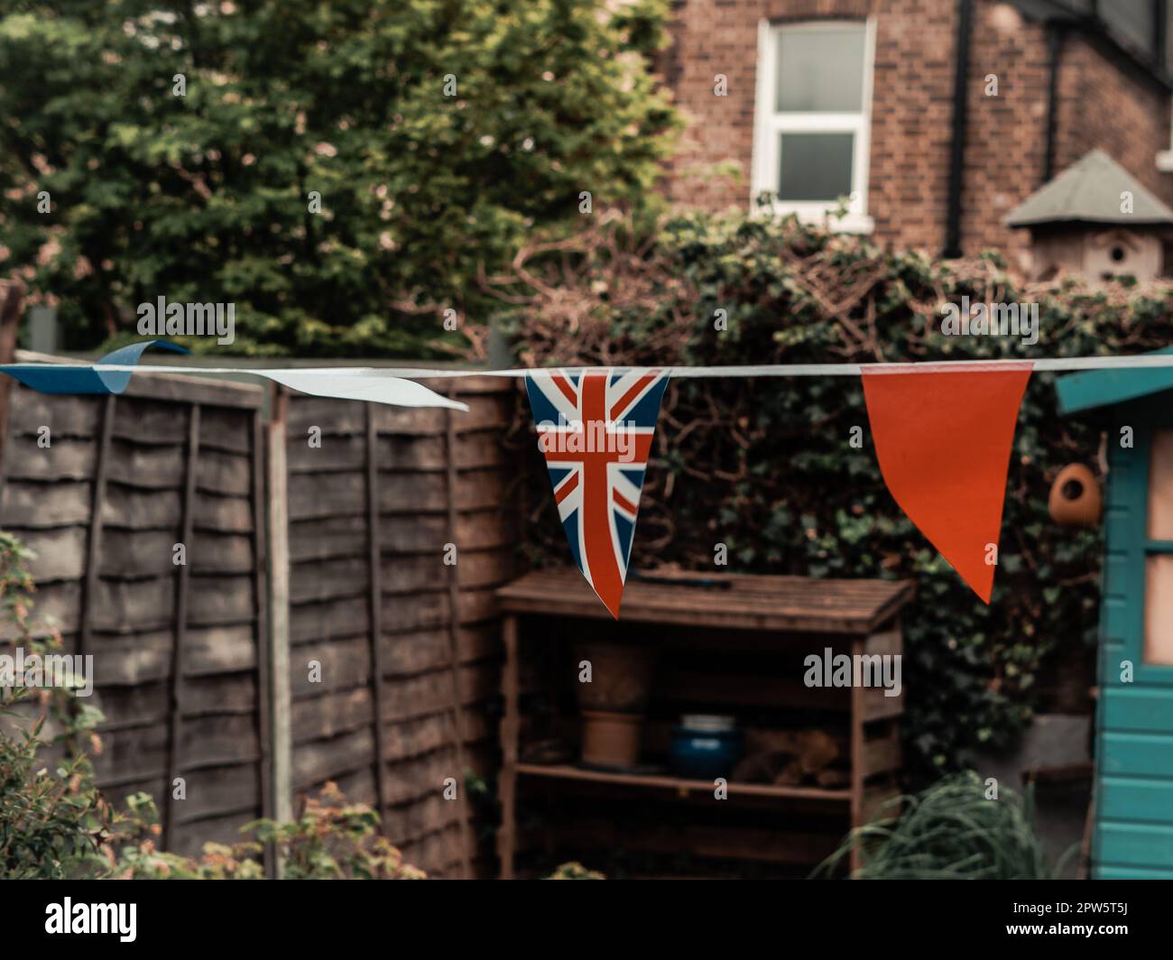 Flags of Great Britain waving on the wind in the garden of English ...
