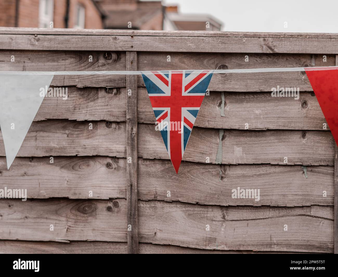 Flags of Great Britain waving on the wind in the garden of English ...