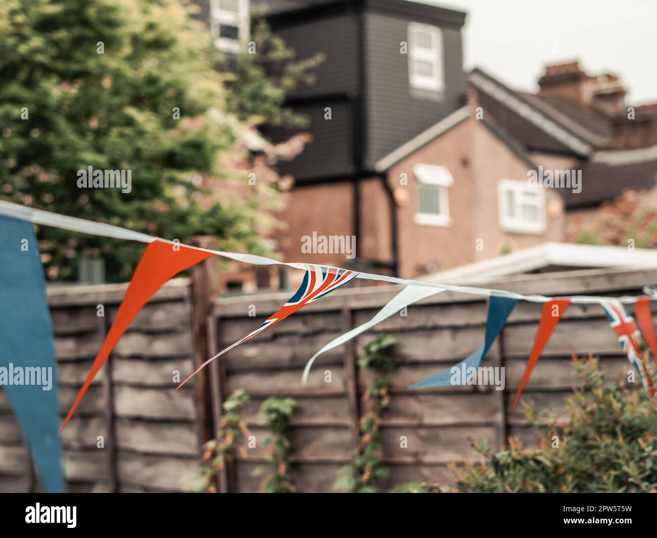 Flags of Great Britain waving on the wind in the garden of English ...
