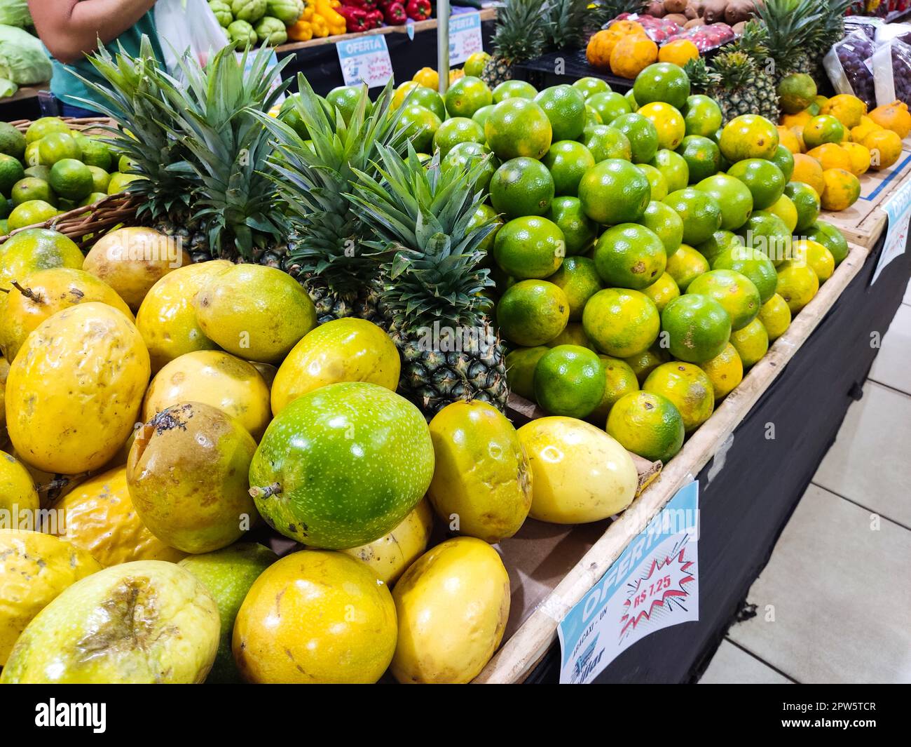 Passion fruit, oranges and pineapples in a supermarket. The PIB (Gross ...