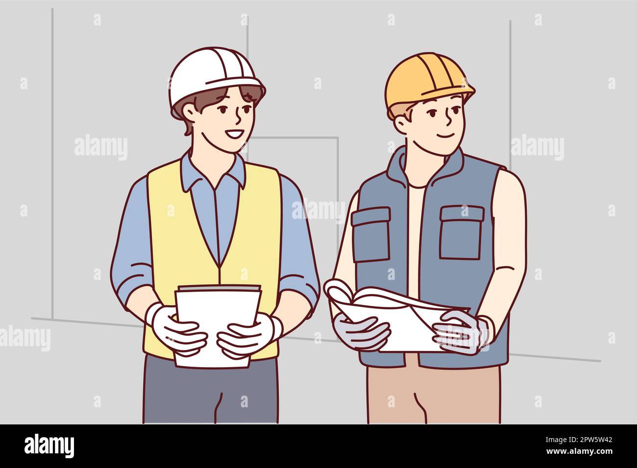 Two male builders in worker uniform look to side discussing ...