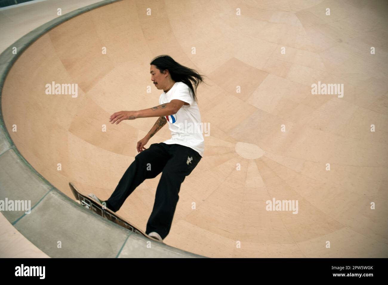 People skateboarding at a custom bowl built inside the Supreme brand ...