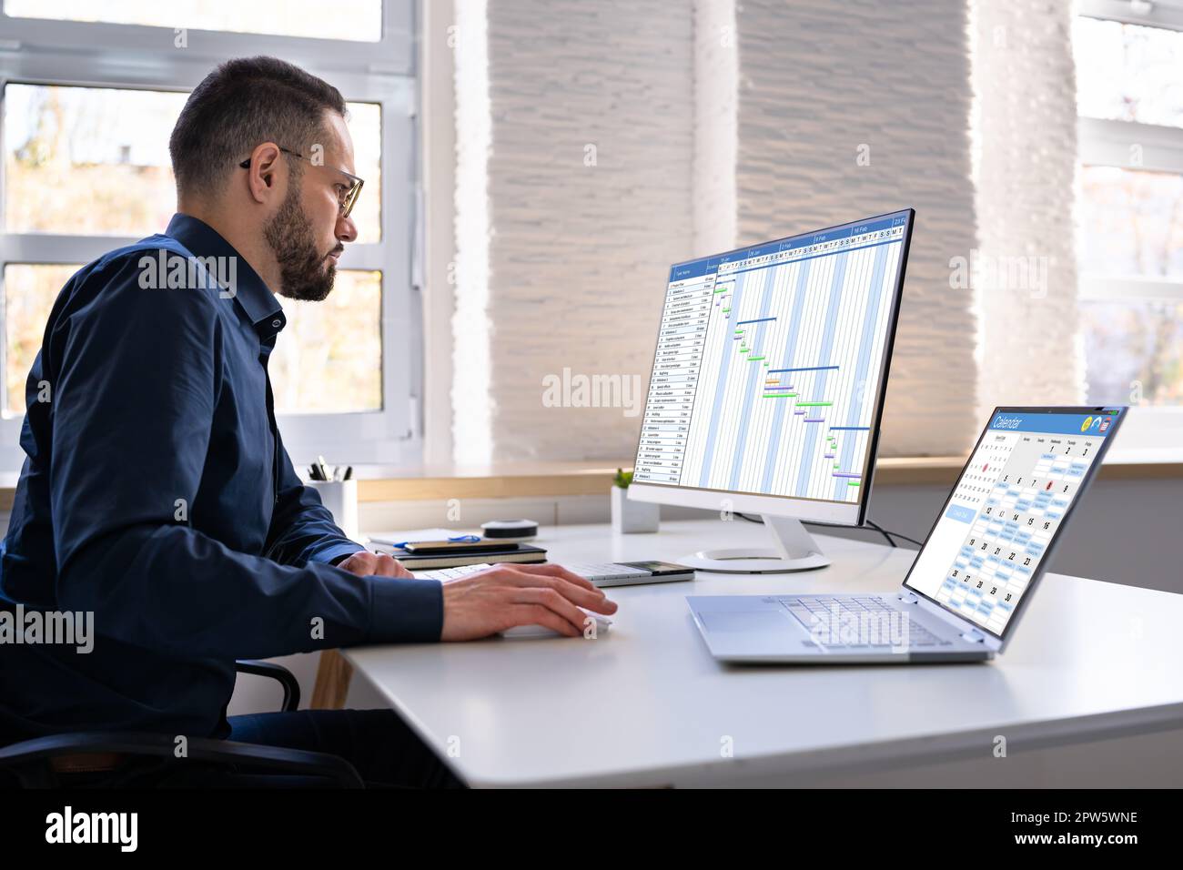 Employee Working On Calendar Schedule And Staff Time Sheet Stock Photo ...