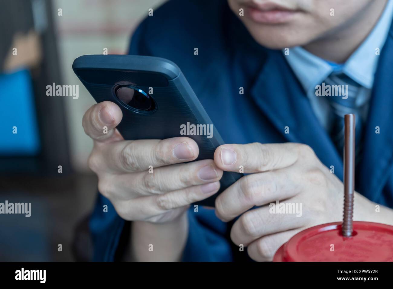 Businessman sitting to check the phone Stock Photo - Alamy