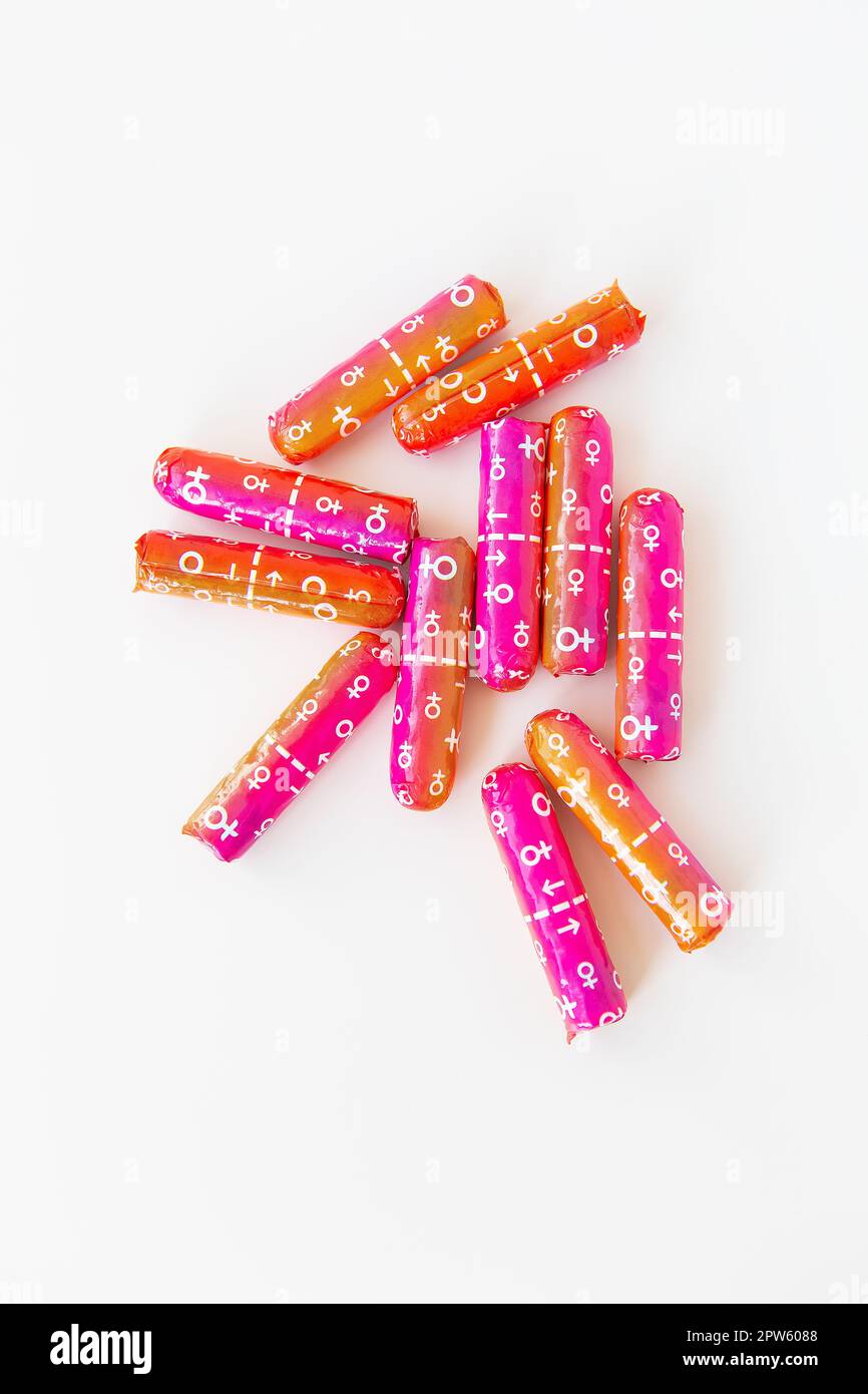 Medical female tampon in pink and orange packaging on a white ...