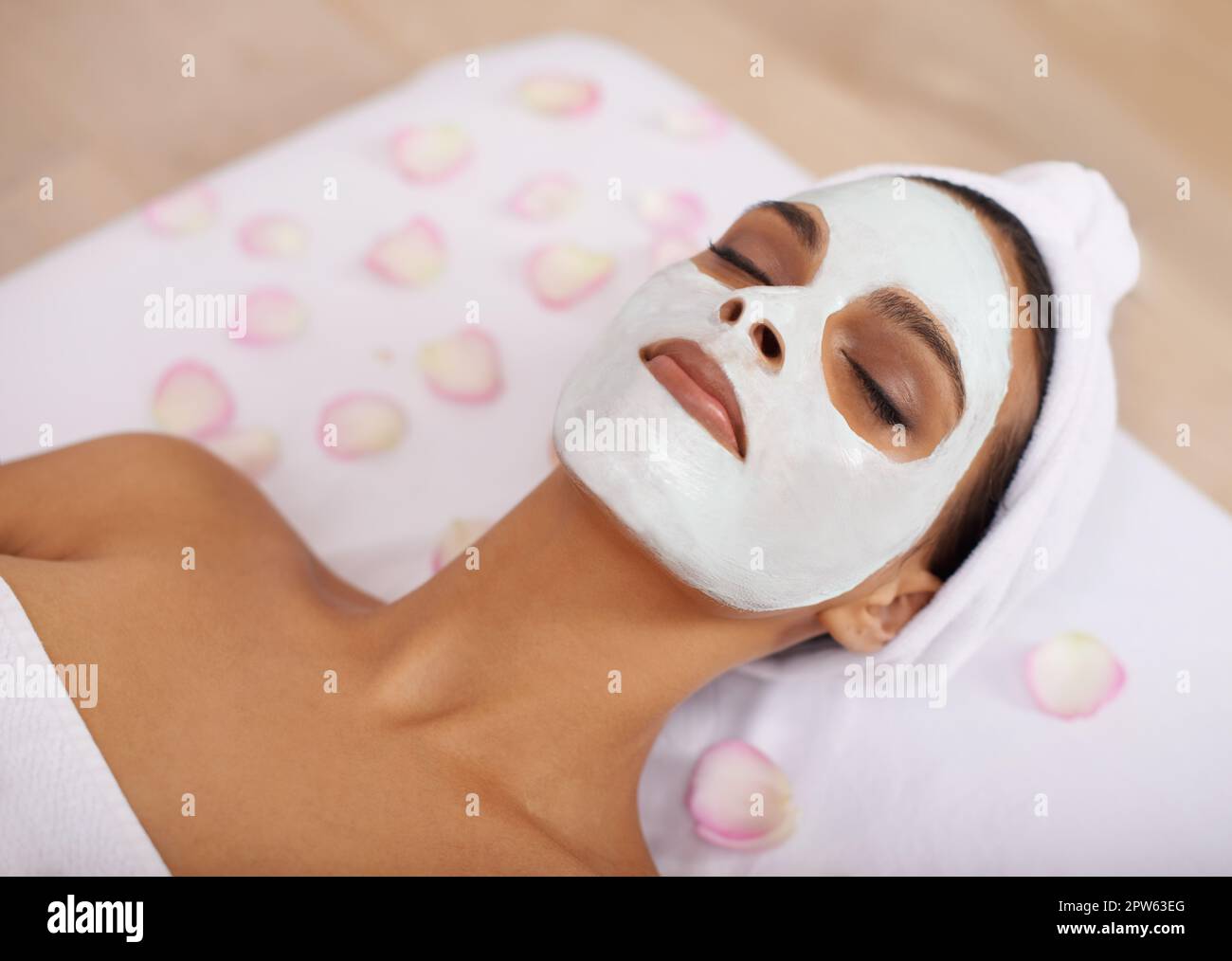Taking time to pamper her skin. a young woman enjoying a facial ...
