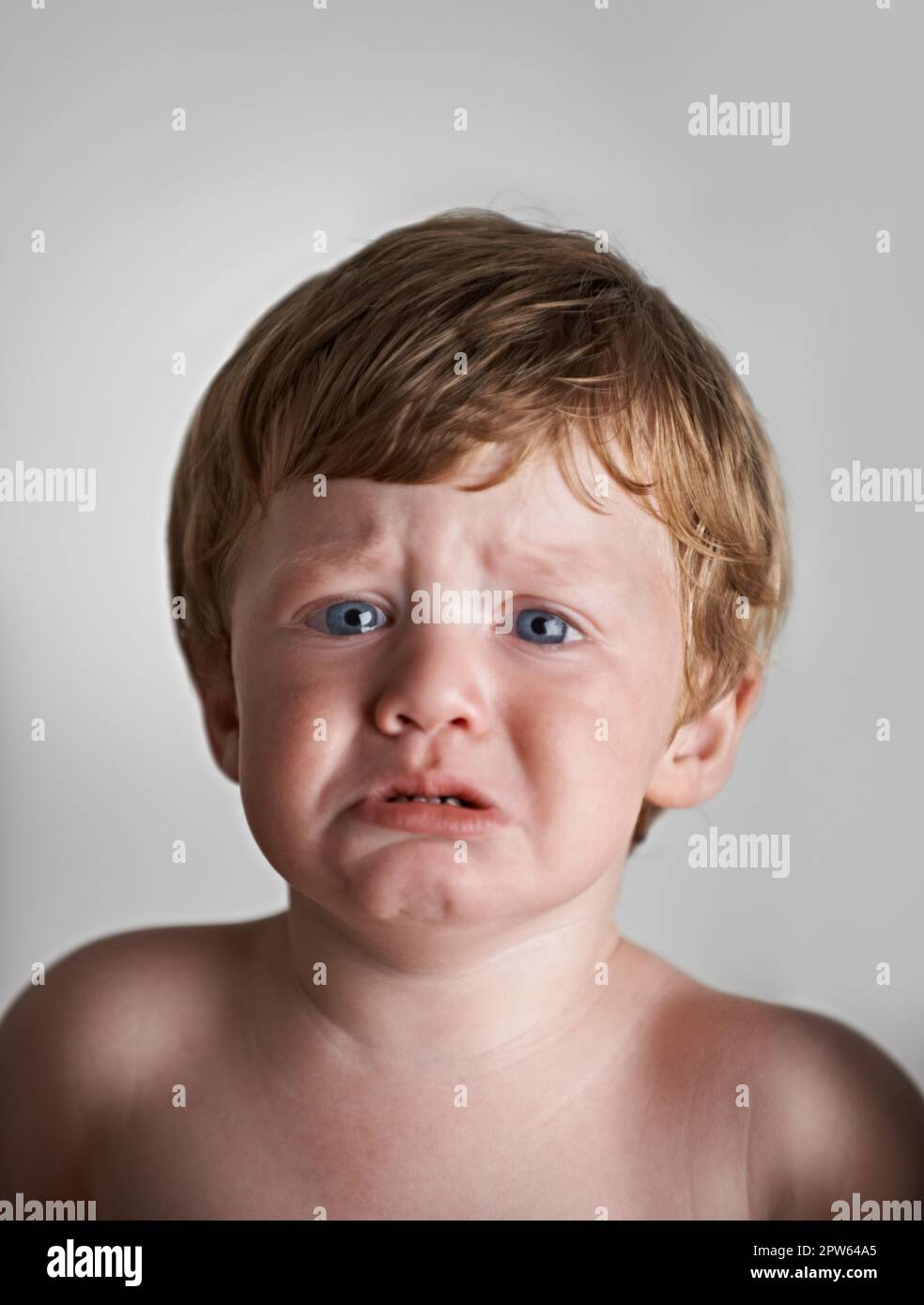 In need of some comforting. Upset red-headed toddler getting ready to ...