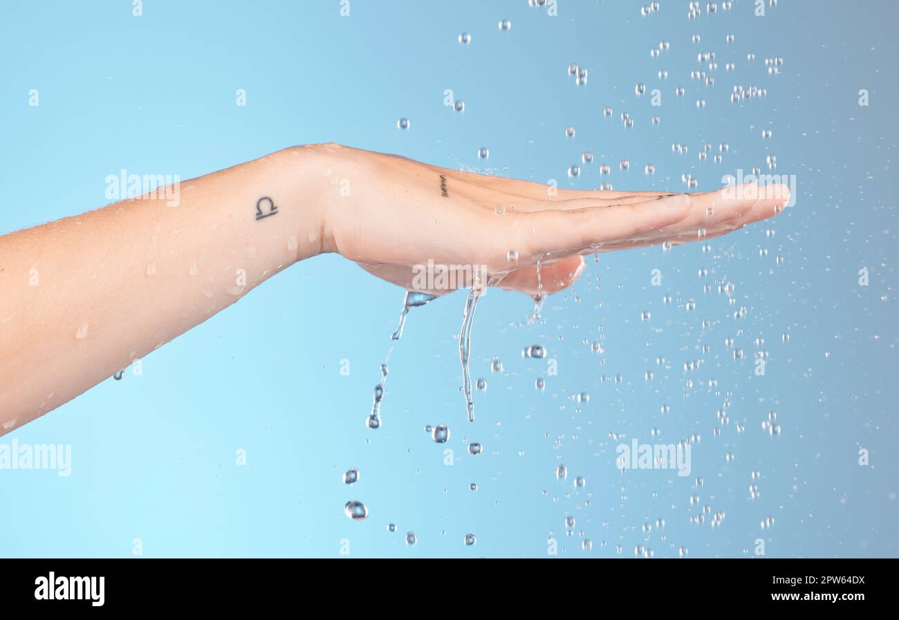 Woman cleaning hands with water splash, shower and beauty for healthy ...