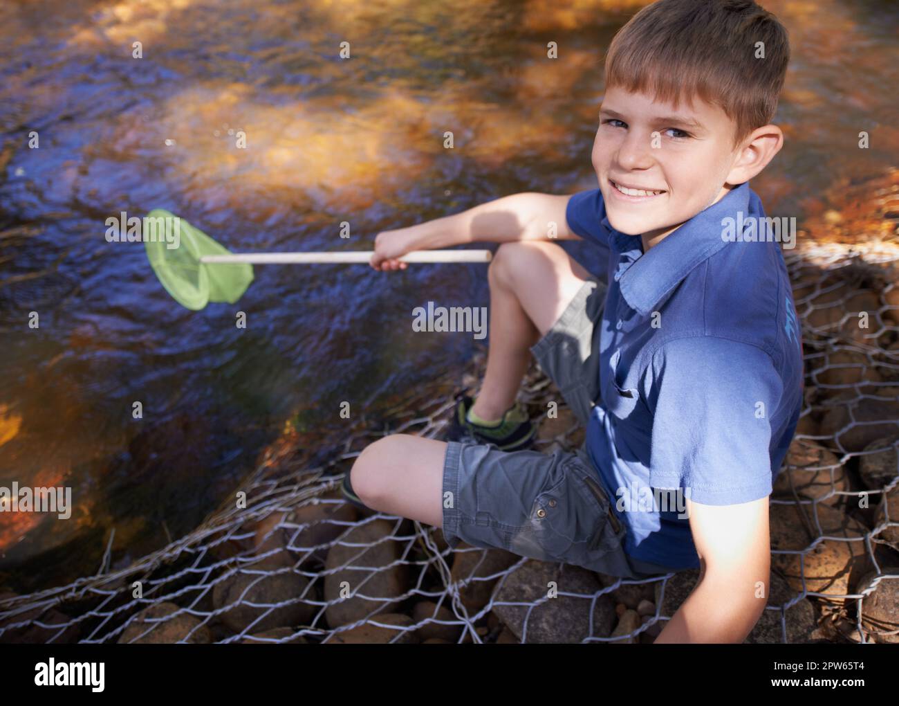Boy holding net catch of fish hi-res stock photography and images - Alamy