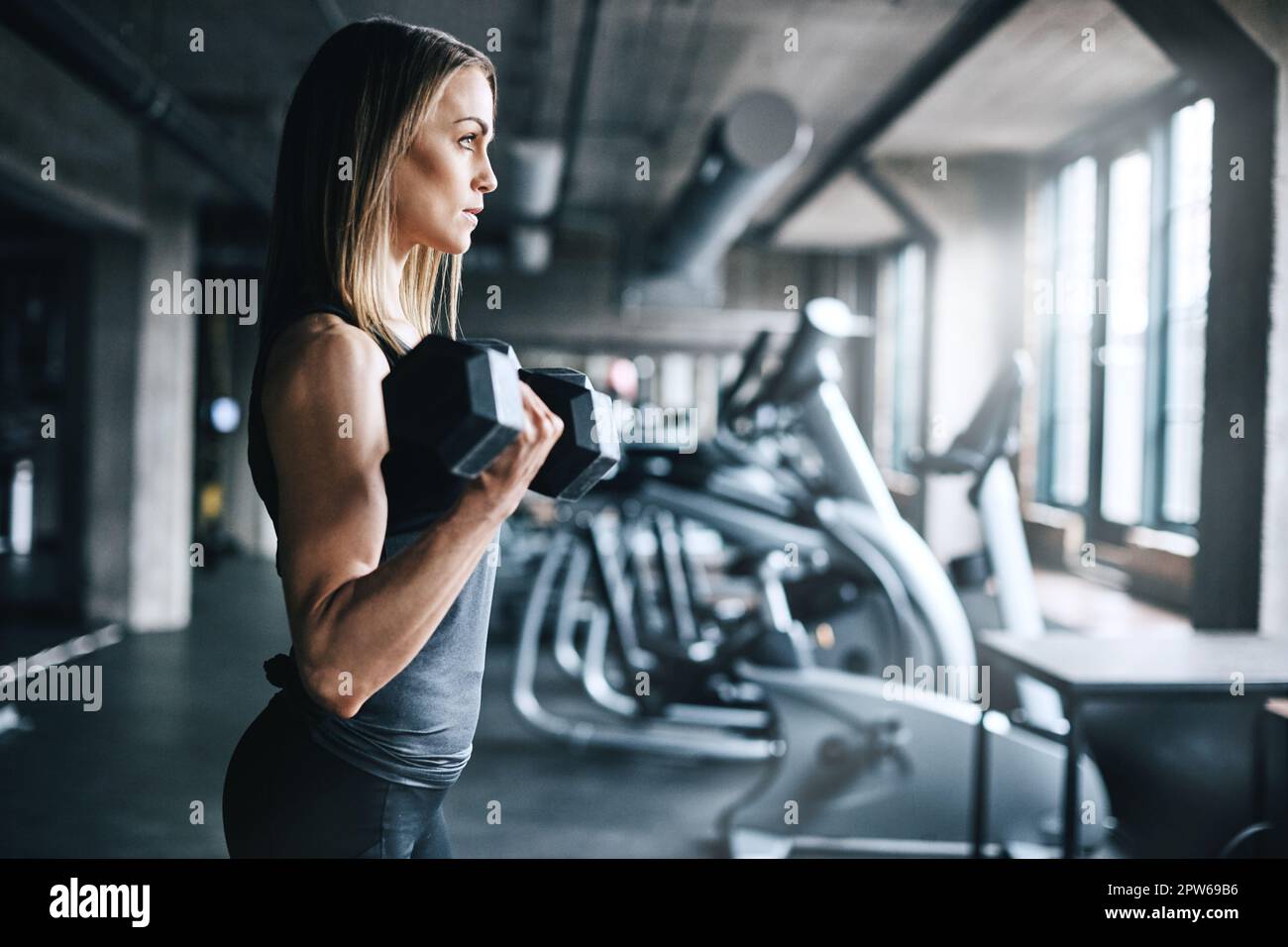 She sets fitness goals, she crushes them. a young woman working out ...