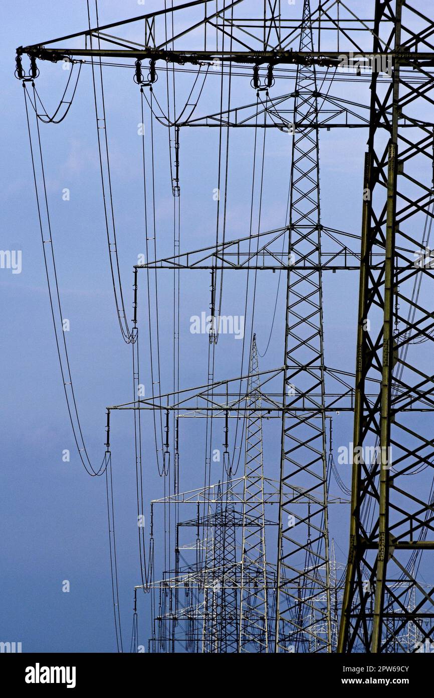 The poles and cables of a power line taken with a telephoto lens in a ...