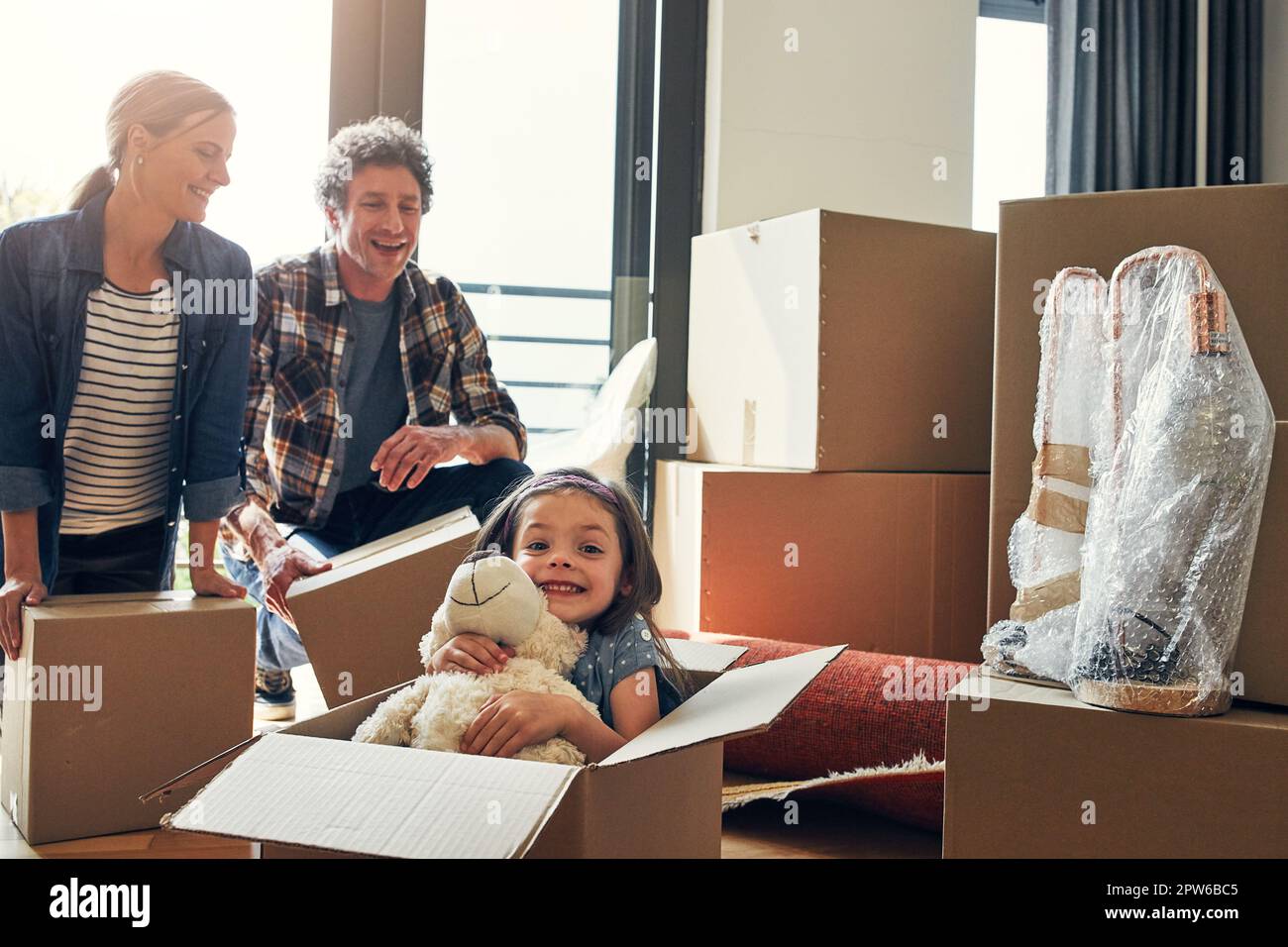 How did she get in the box again. Portrait of a cheerful loving family ...