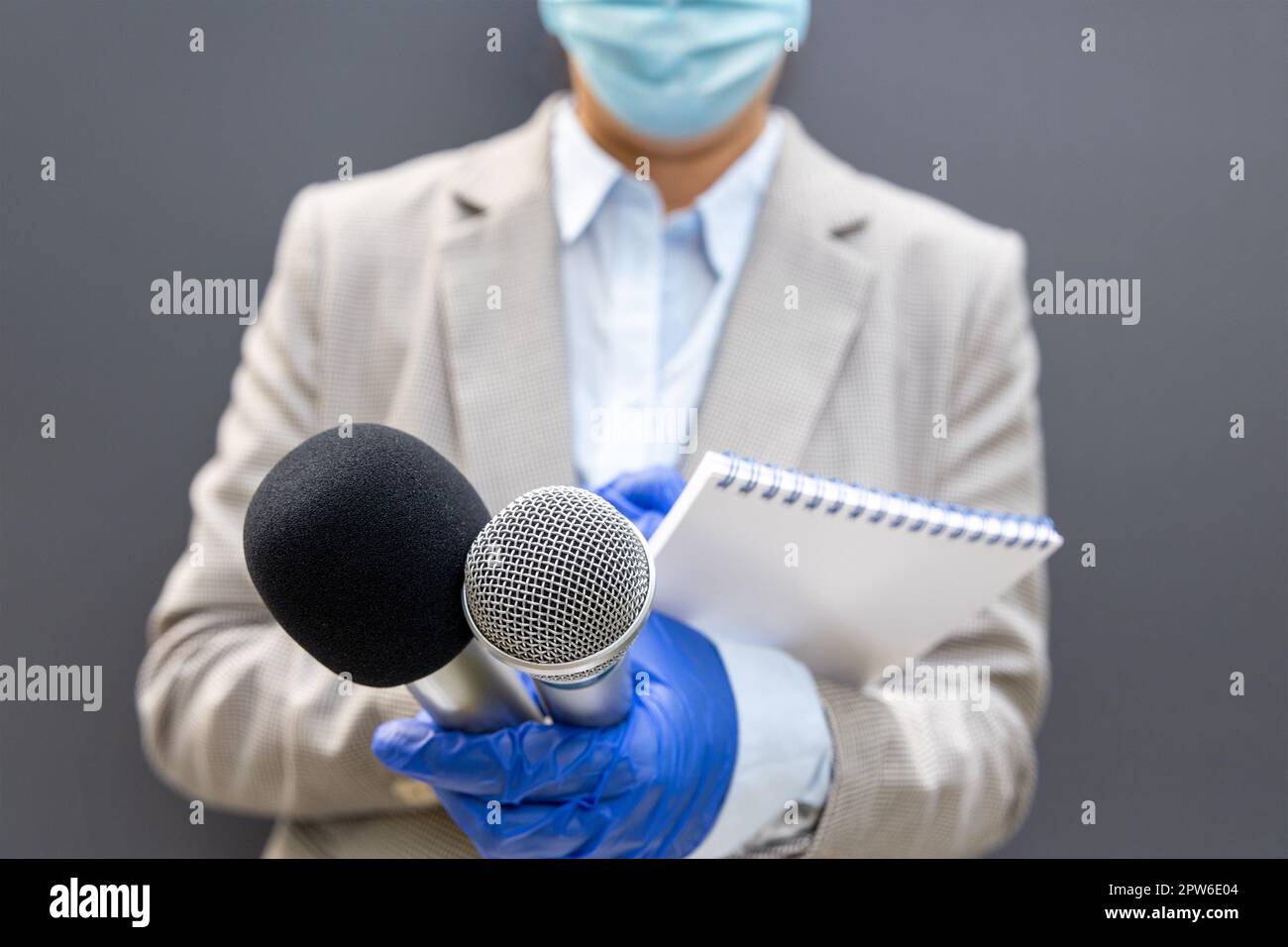 Female reporter wearing protective gloves and face mask against ...